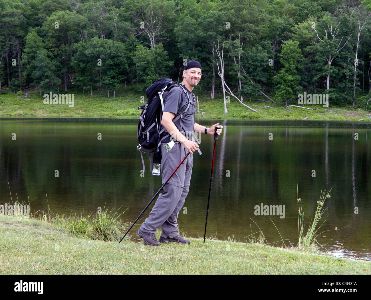 Male hiker with walking sticks Stock Photo - Alamy