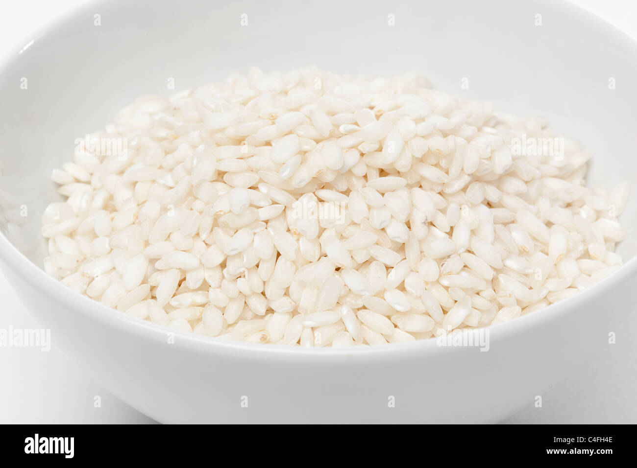 Dry White Rice against a white background Stock Photo - Alamy