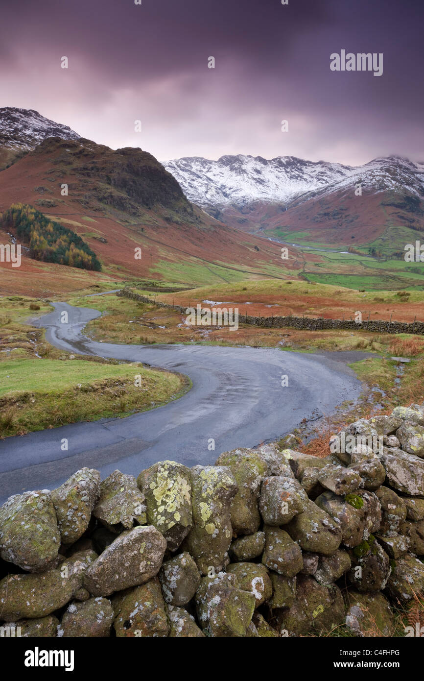 A winding mountain road descends into Great Langdale valley, Lake ...