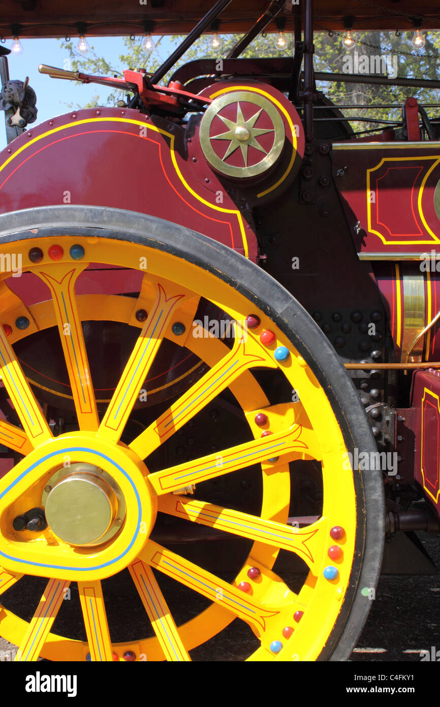 Colourfully painted and decorated wheel of a steam engine at a steam ...