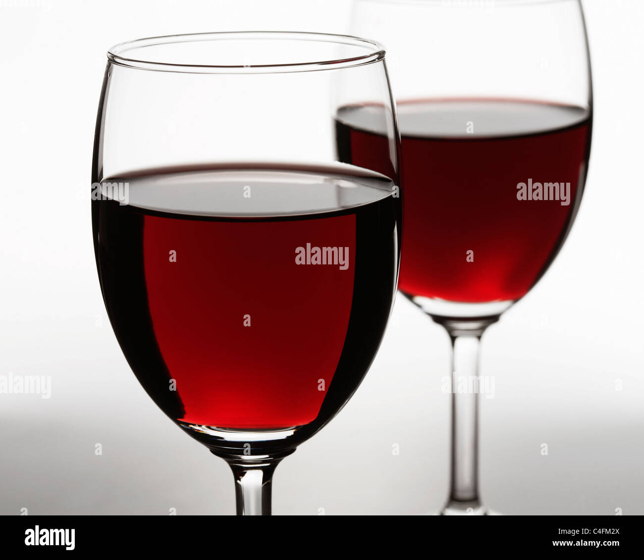 Red wine on white background. Focus is on the first glass Stock Photo ...