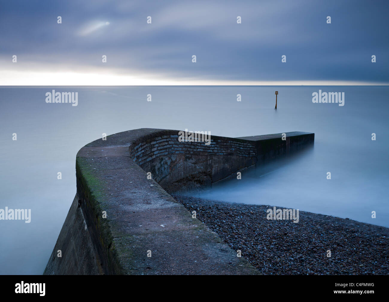 Stone jetty on the seafront at Sidmouth, Devon, England. Winter ...