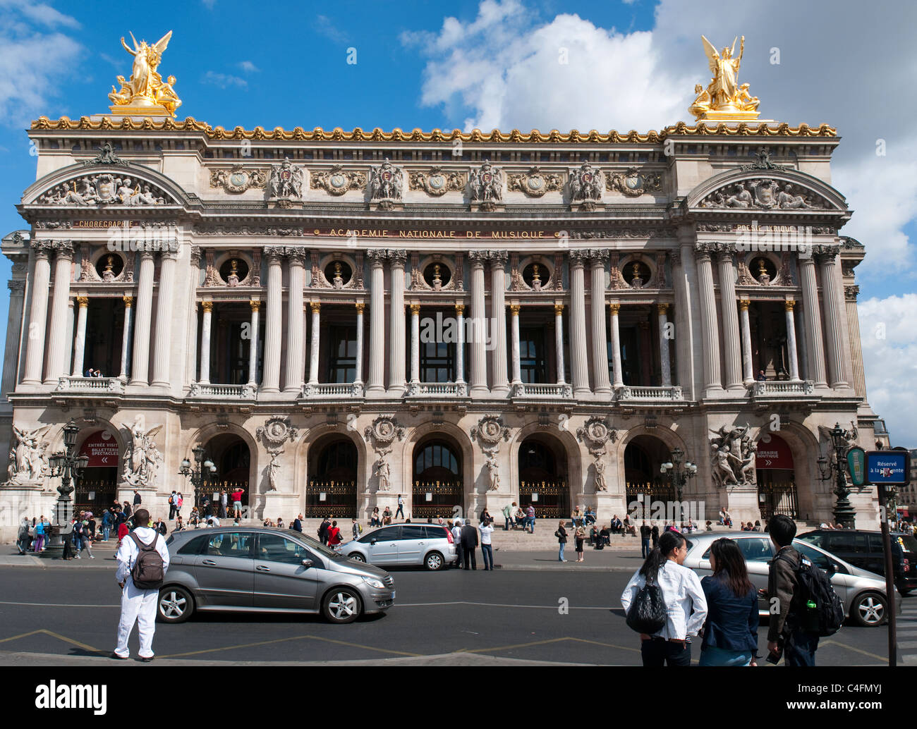 Tourists visit the Opera Garnier, a grand landmark in Paris, France ...