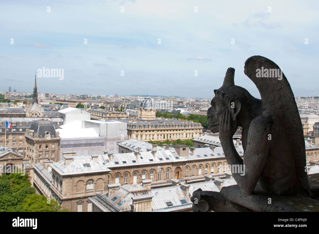Famous Chimera (Stryge) overlooking the Paris from Notre Dame of Paris ...