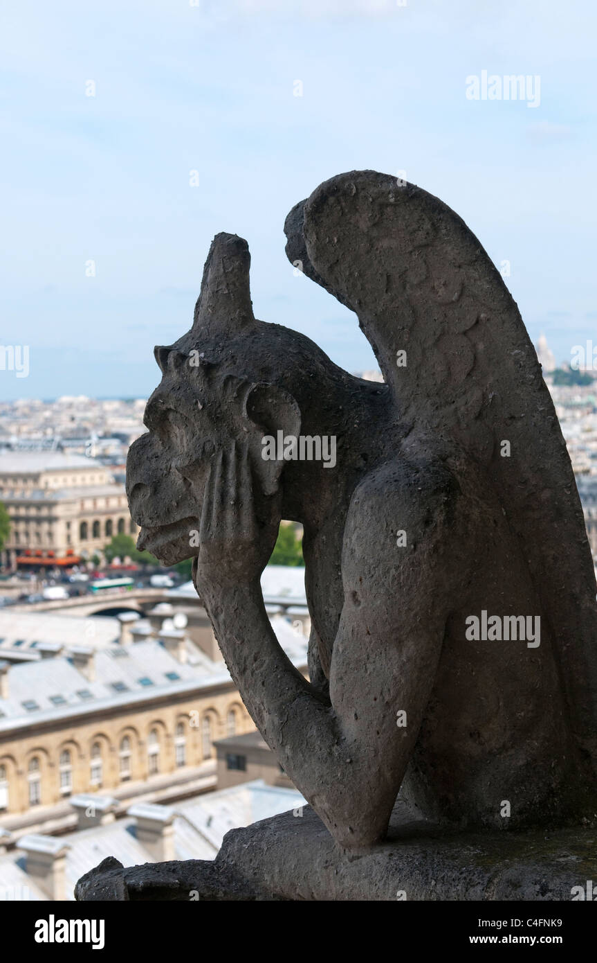 Famous Chimera (Stryge) overlooking the Paris from Notre Dame of Paris ...
