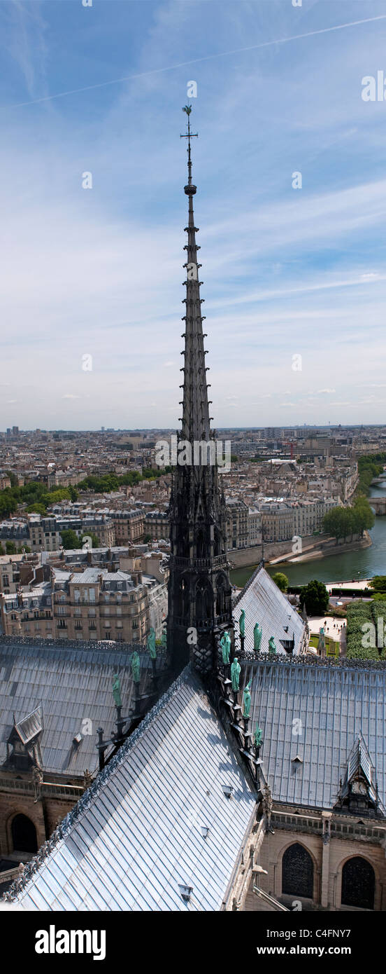 View on tall spire of Notre Dame from the top of cathedral. France ...