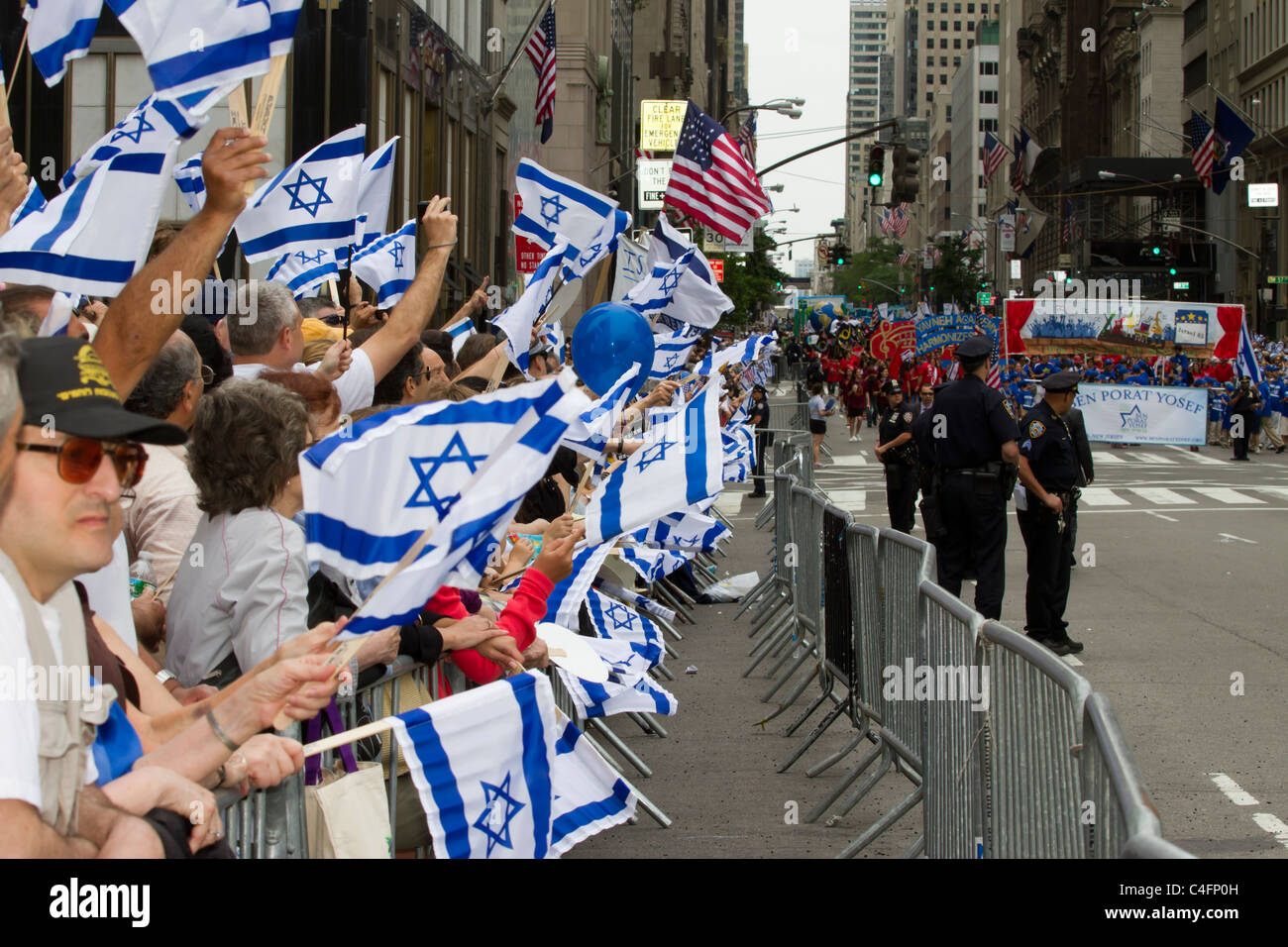 Spectators wave Israeli flags at the 2011 Celebrate Israel Parade on ...