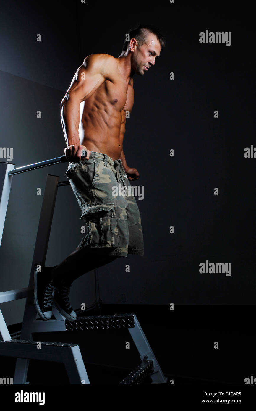 fit male working out in a gym shirtless Stock Photo - Alamy