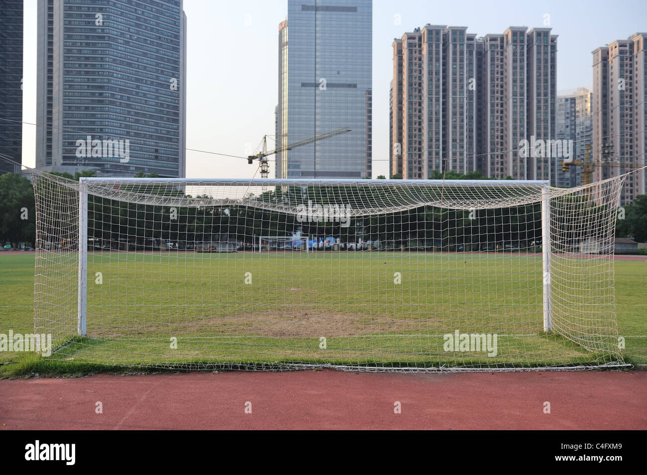 football goal with football field and buildings as background Stock ...