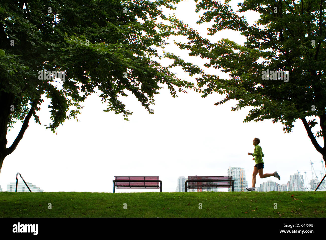 Ultra marathon female runner running in the city of Vancouver BC Canada ...