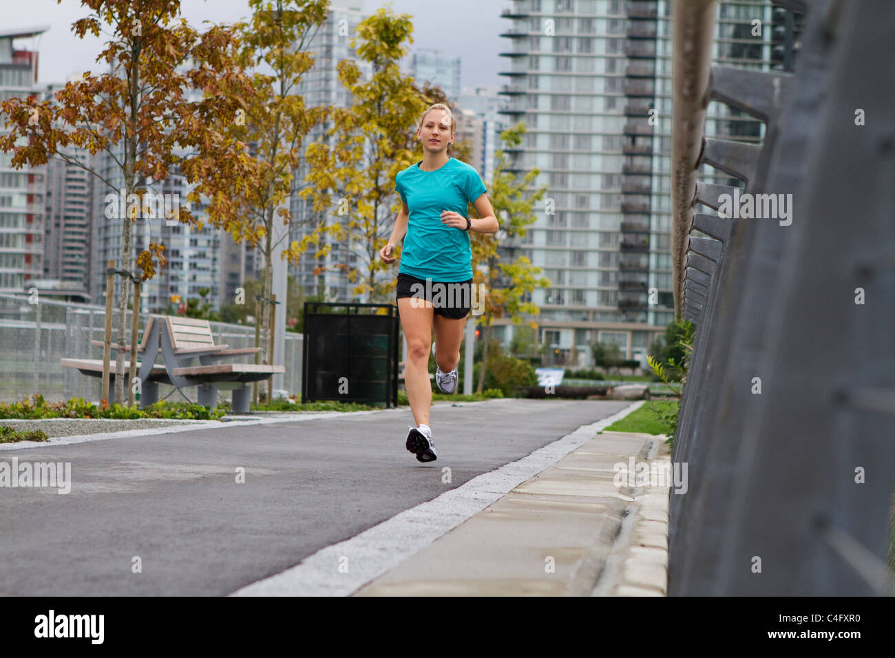 Ultra marathon female runner running in the city of Vancouver BC Canada ...