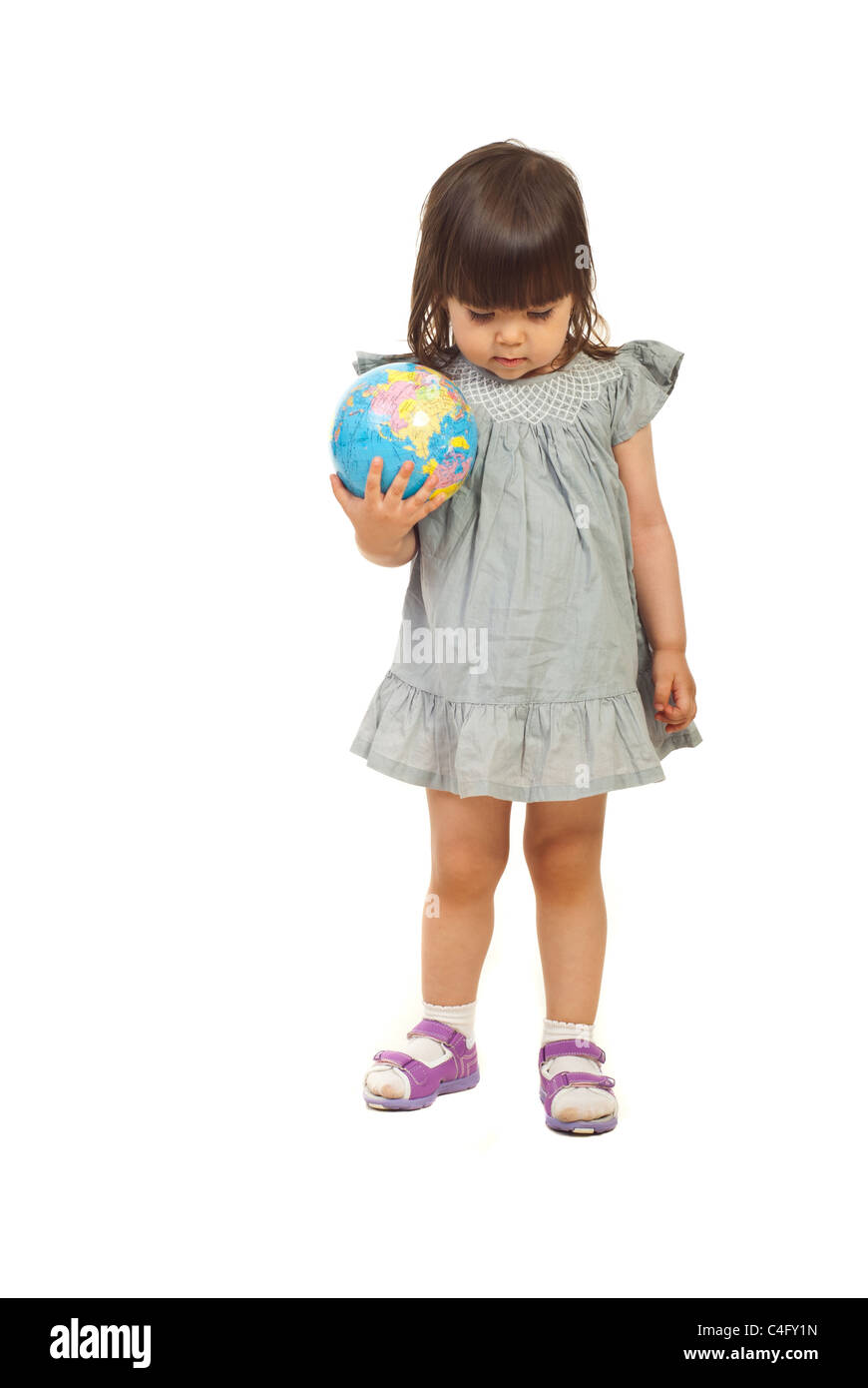 Little child girl two years old holding globe and meditate isolated on ...