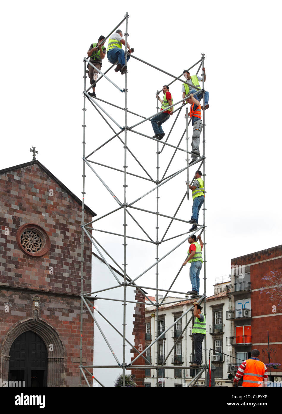 Team of men erecting scaffolding Stock Photo - Alamy