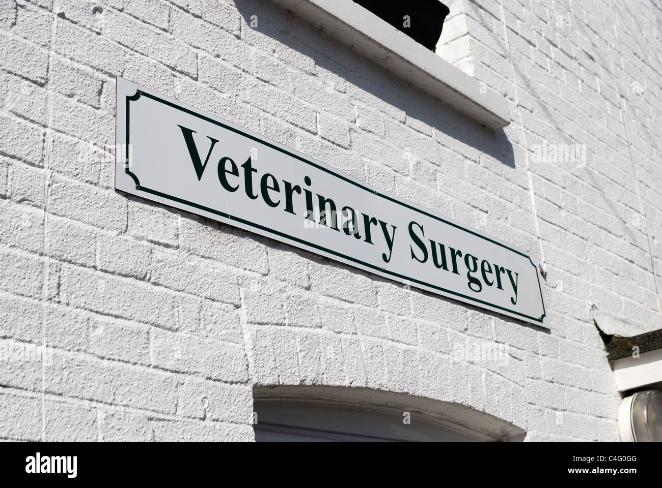 Sign on white painted brick wall for Veterinary Surgery Stock Photo - Alamy