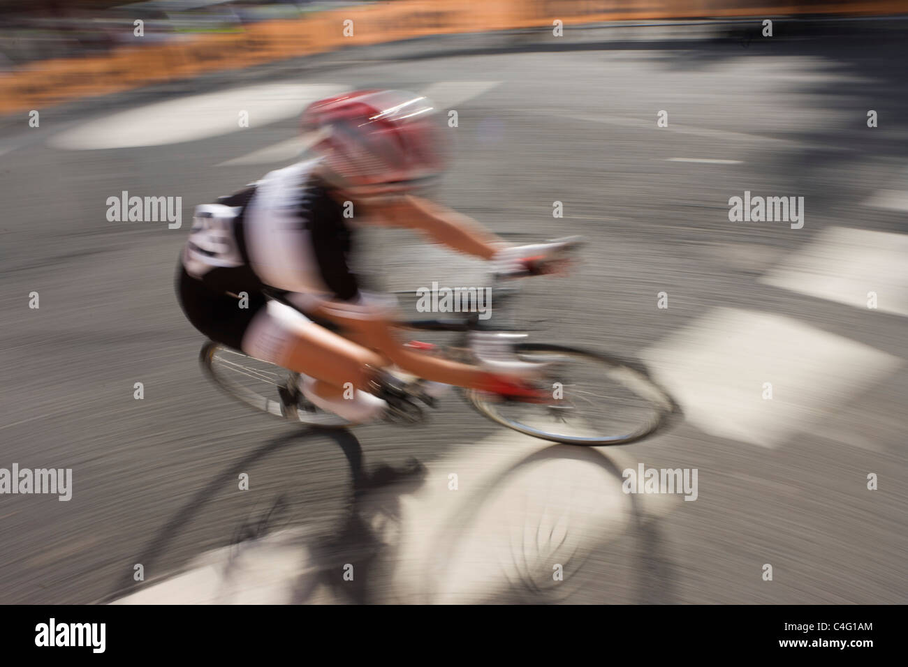 With bike shadows, blurred women cyclists turn into a corner of a ...