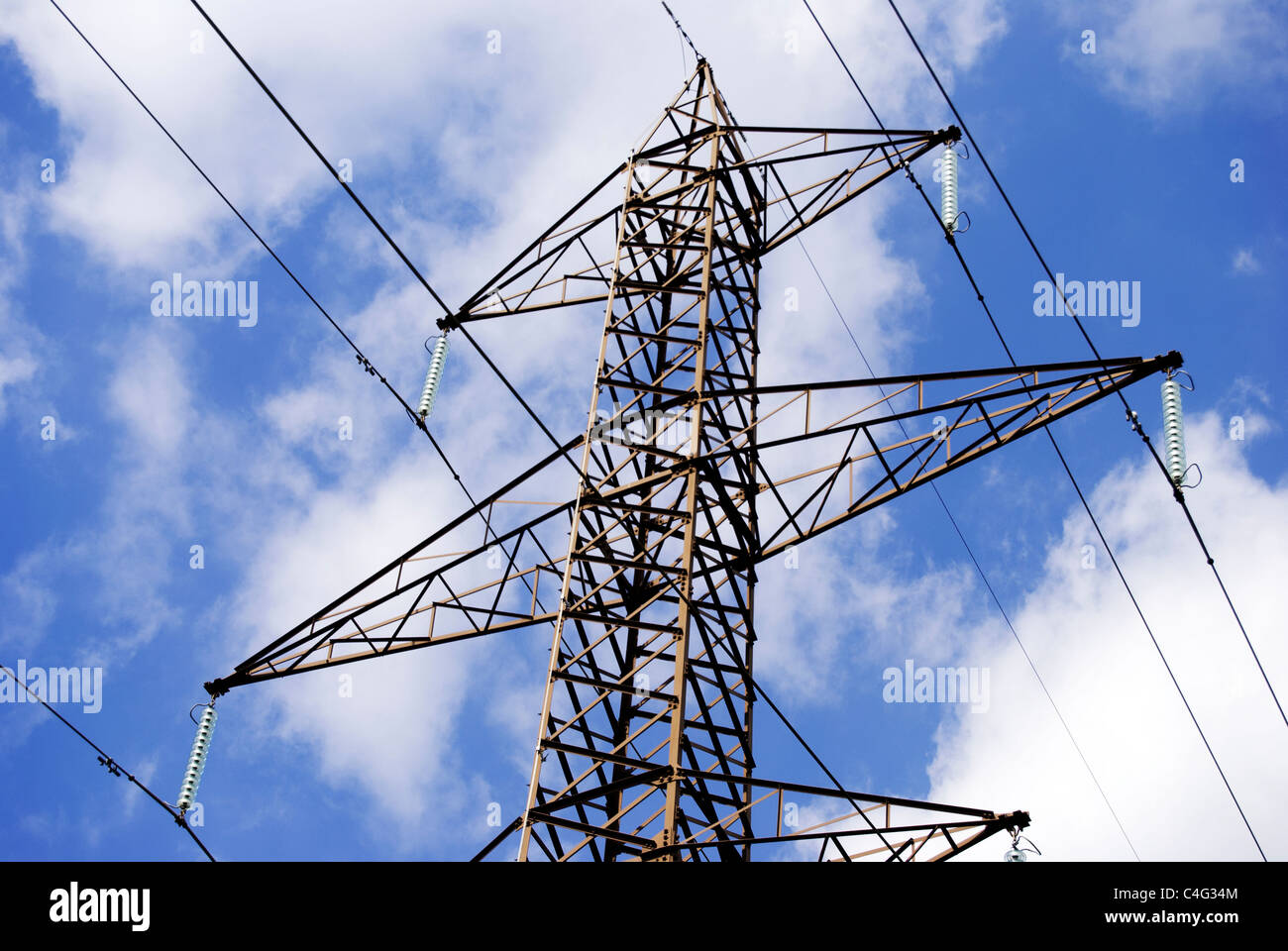 Electricity pylons with long cable at day Stock Photo - Alamy