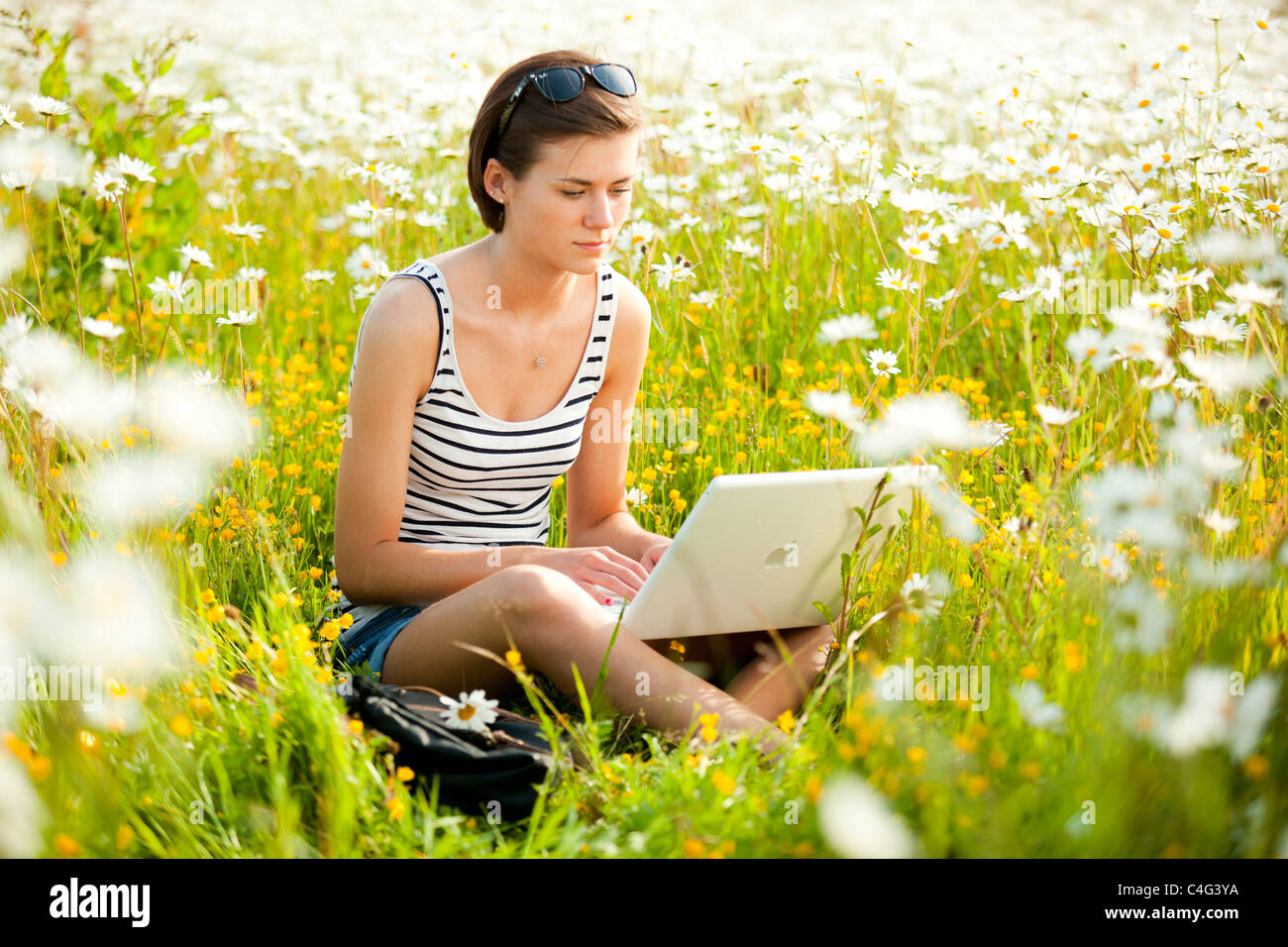 Girl working outdoors with laptop Stock Photo - Alamy