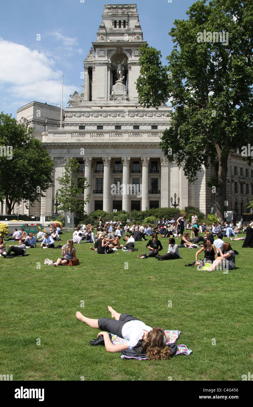 Office workers having a lunch break at Trinity Square in the City of ...