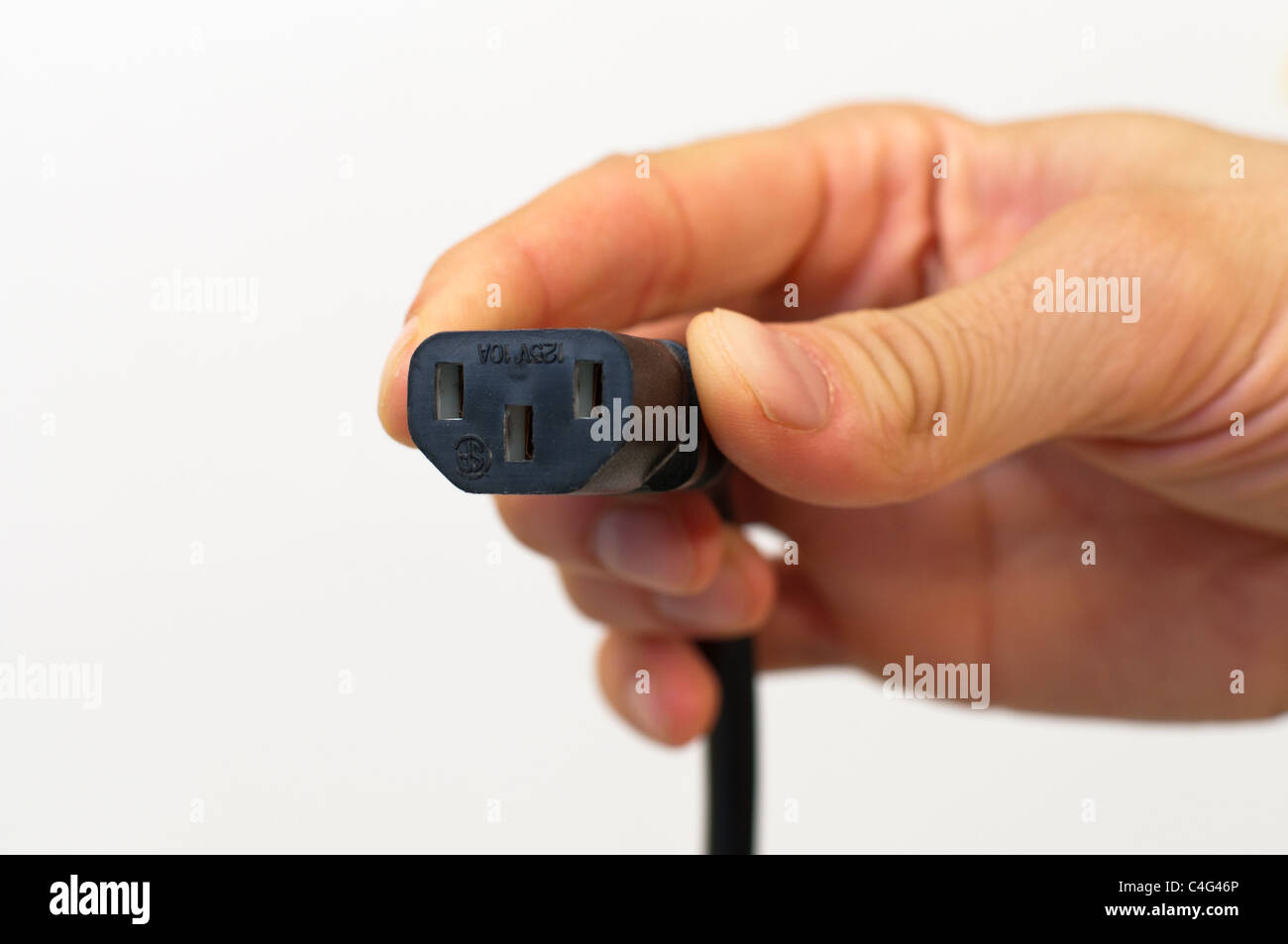 Hand holding a power supply electrical cord Stock Photo - Alamy