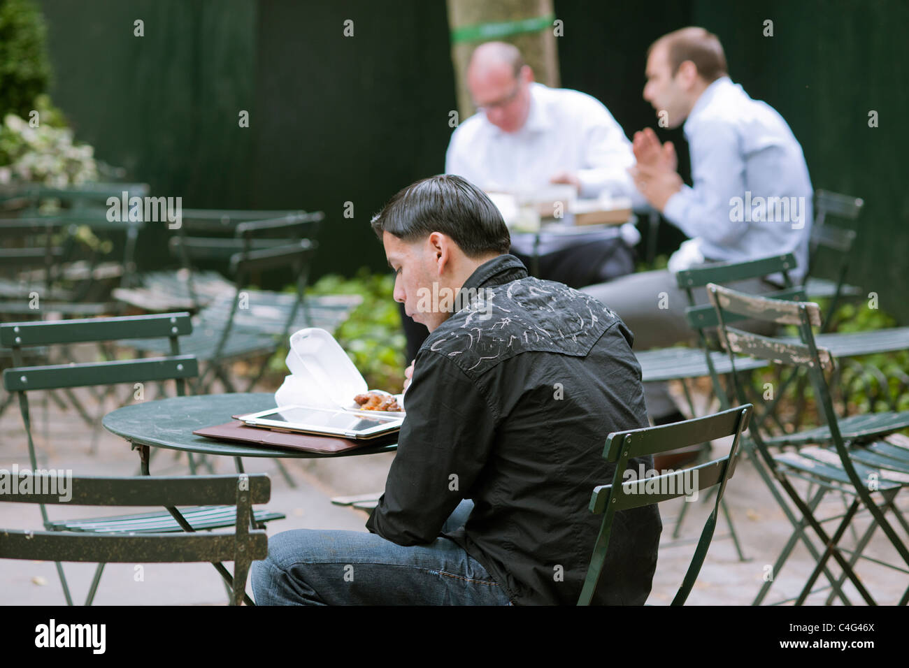 An Apple iPad user with his tablet computer in Bryant Park in New York ...