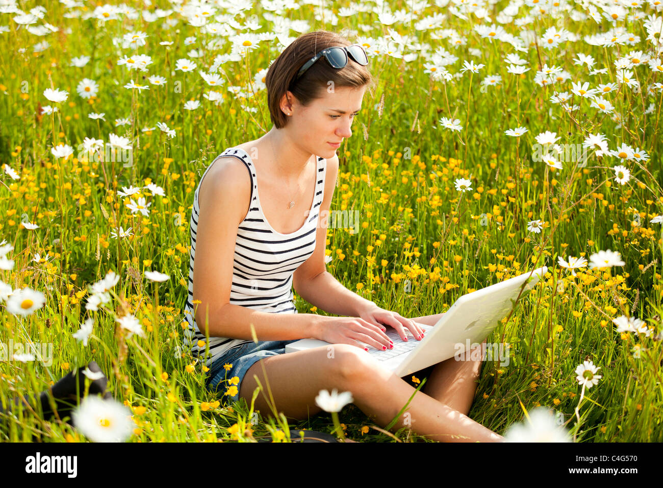 Girl working outdoors with laptop Stock Photo - Alamy