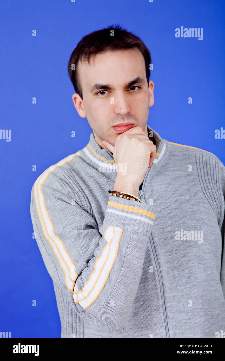 an casual young man portrait over a blue background Stock Photo - Alamy an casual young man portrait over a blue background Stock Photo - Alamy