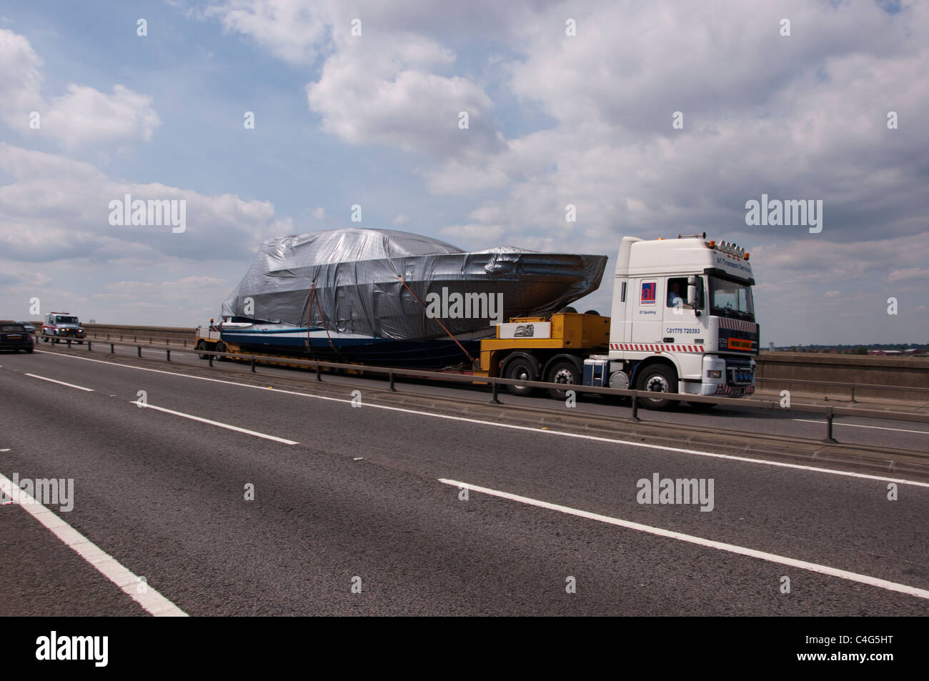Wide load lorry carrying boat Stock Photo - Alamy