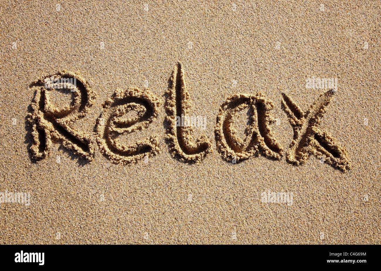 Relax, written on a sandy beach Stock Photo - Alamy