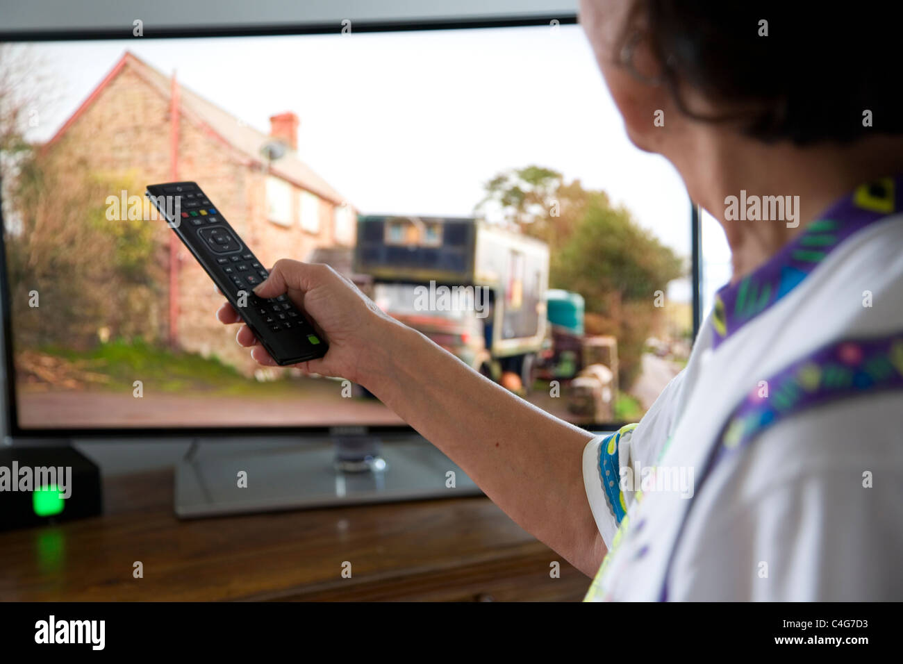 Mature woman and tv remote hi-res stock photography and images - Alamy