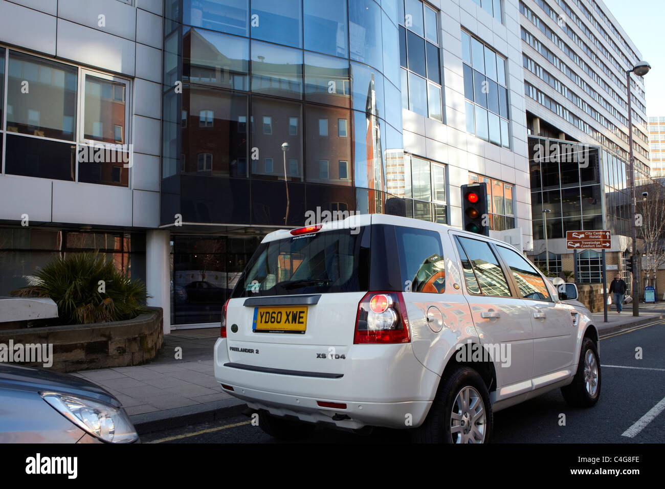 White Land Rover driving in Leeds City Centre Stock Photo - Alamy