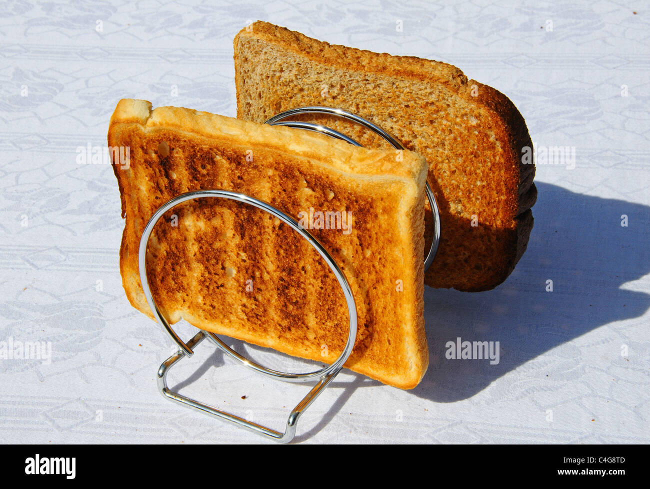 Two slices of toast in a chrome coiled toast rack Stock Photo - Alamy