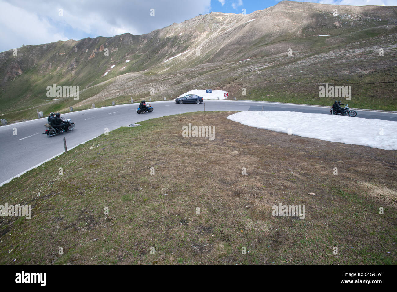 Motorcycles taking a tight bend on the Grossglockner mountain road ...