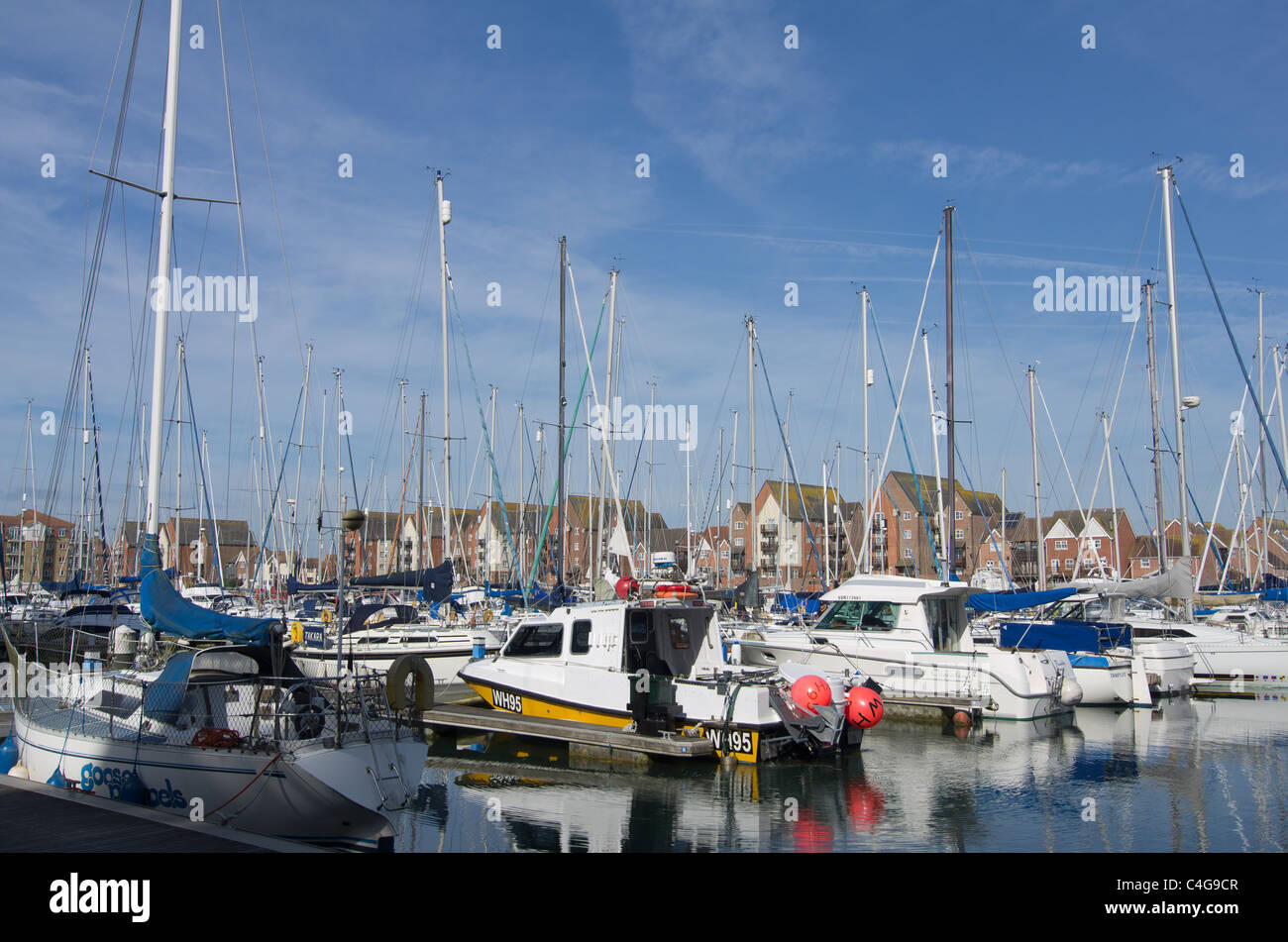 busy marina full of boats and yachts at Sovereign Harbour, Eastbourne ...