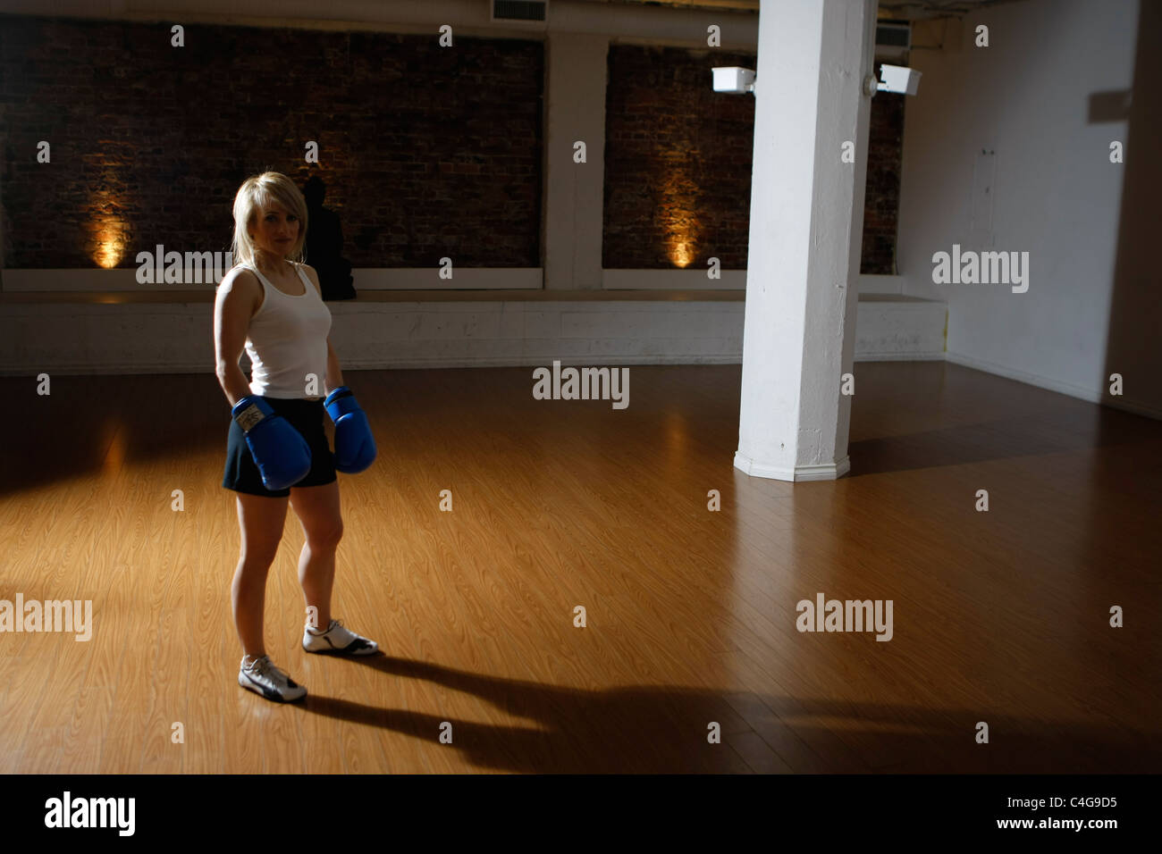 girl boxing with blue gloves and working out Stock Photo - Alamy
