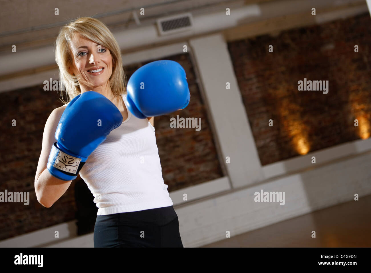 girl boxing with blue gloves and working out Stock Photo - Alamy