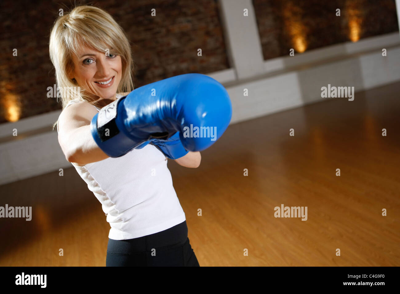 girl boxing with blue gloves and working out Stock Photo - Alamy