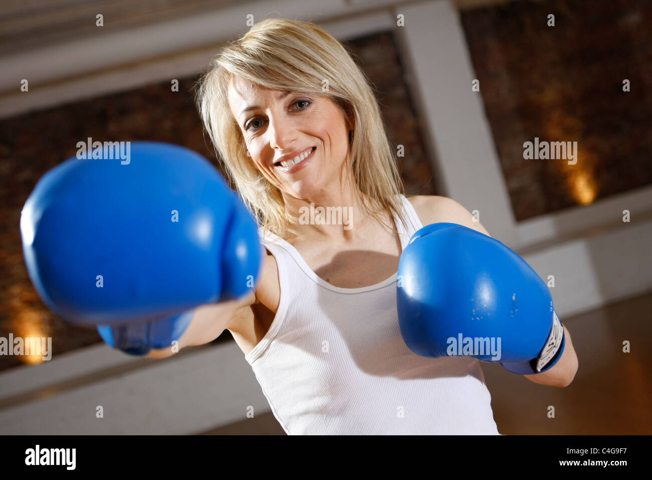 girl boxing with blue gloves and working out Stock Photo - Alamy