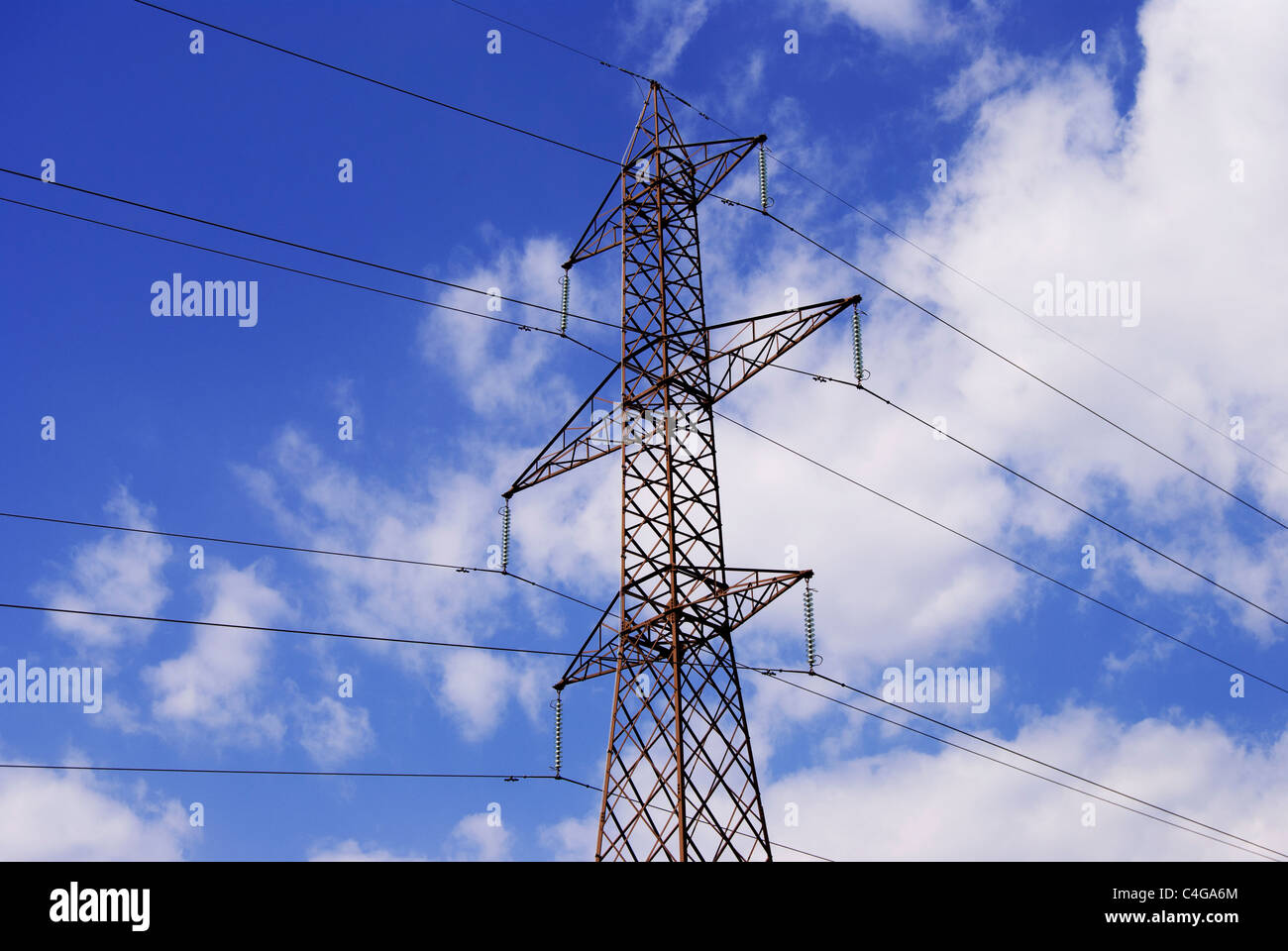 Electricity pylons with long cable at day Stock Photo - Alamy