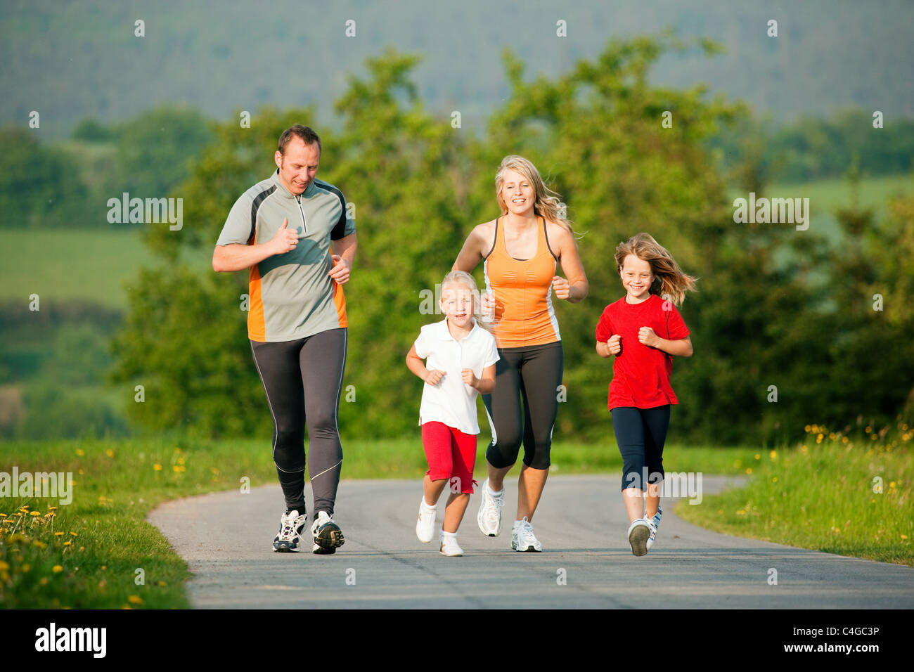 Family jogging outdoors with the kids Stock Photo - Alamy