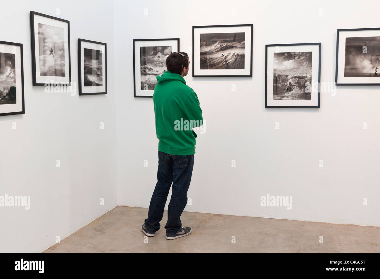Man viewing the Ed Freeman Photography Gallery opening of his new ...