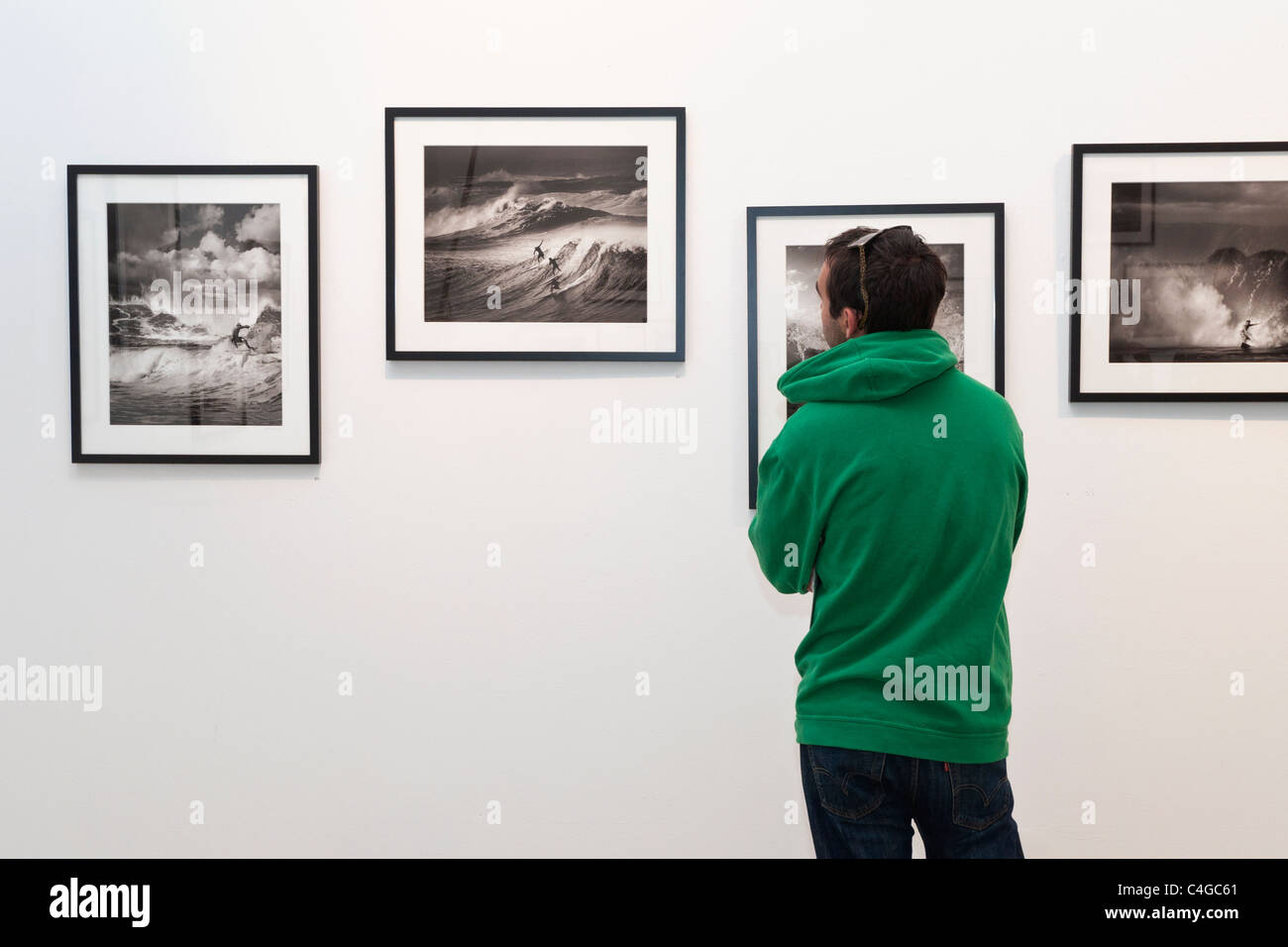 Man viewing the Ed Freeman Photography Gallery opening of his new ...