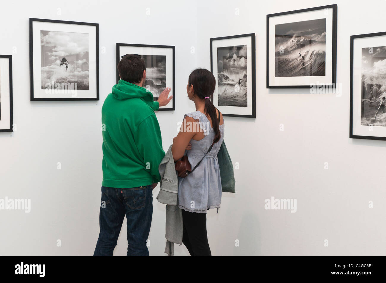 Couple viewing the Ed Freeman Photography Gallery opening of his new ...