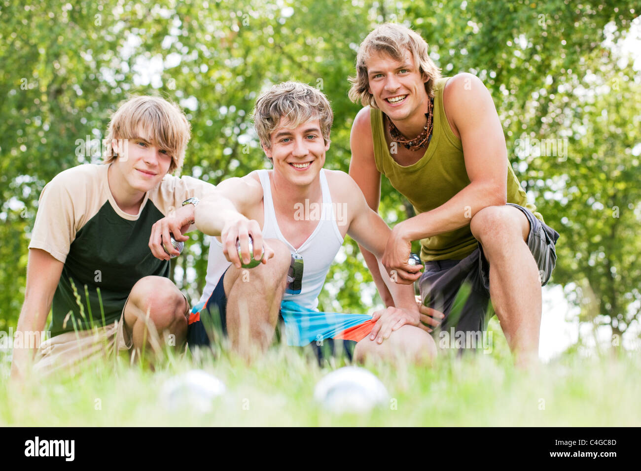Group of young men playing boule in a park outdoors in summer Stock ...
