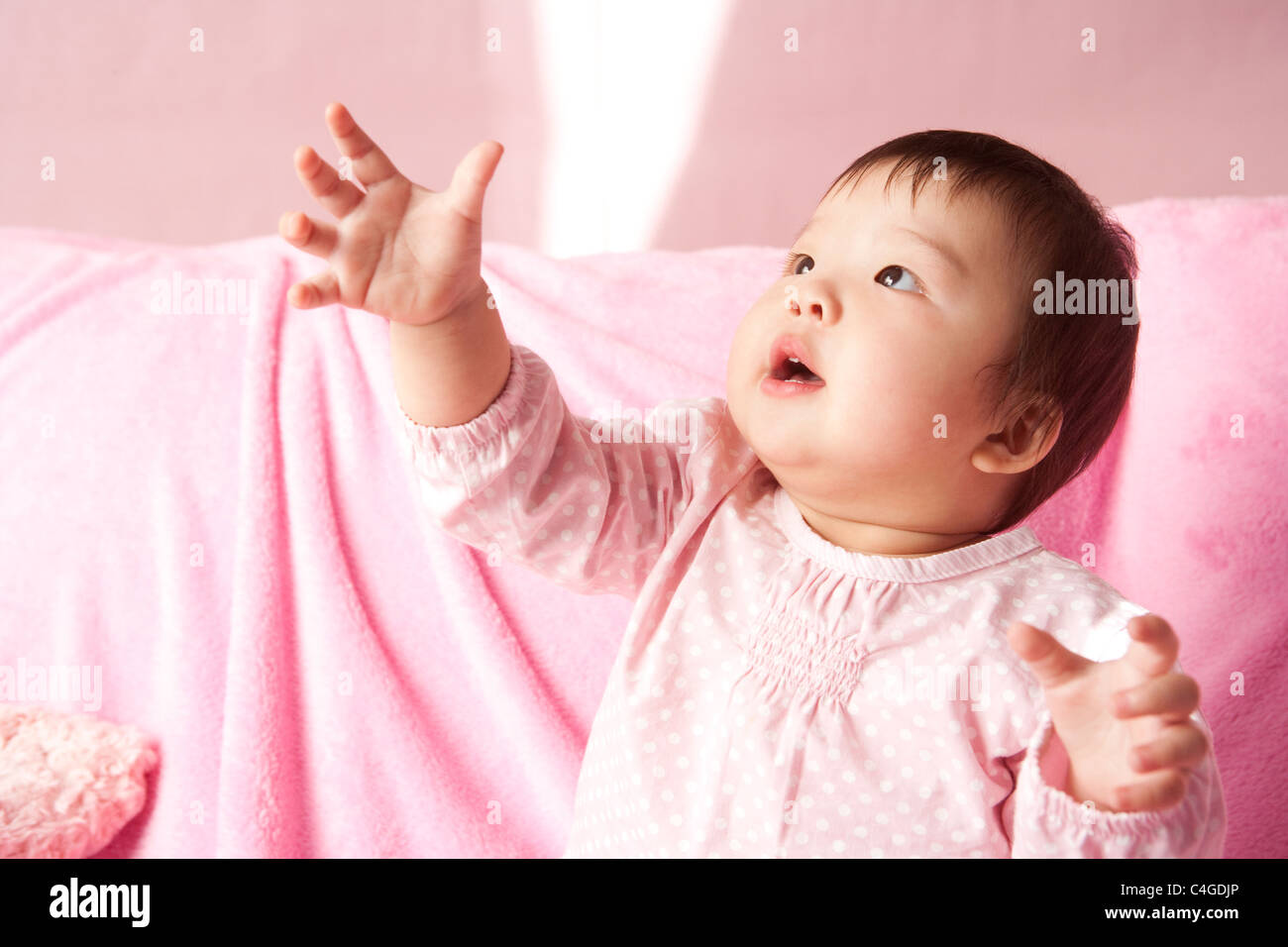 Baby with arms reaching up hi-res stock photography and images - Alamy