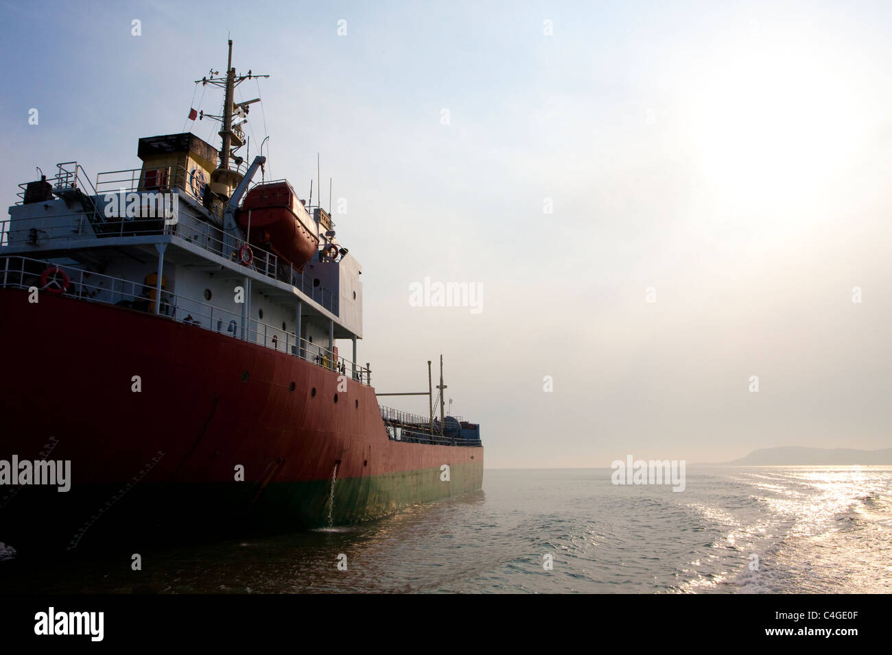 Cargo ship sailing through the sea Stock Photo - Alamy