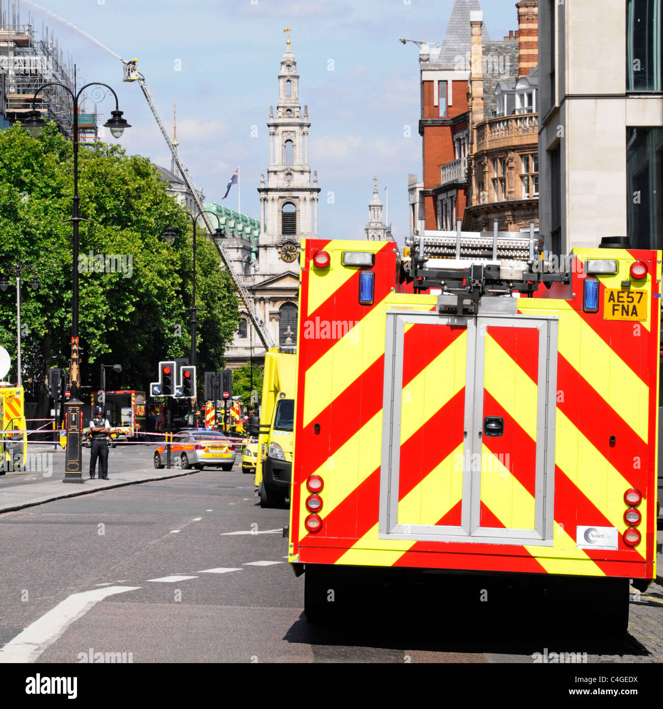 Telescopic ladder & access platform firefighter at work aiming water at ...