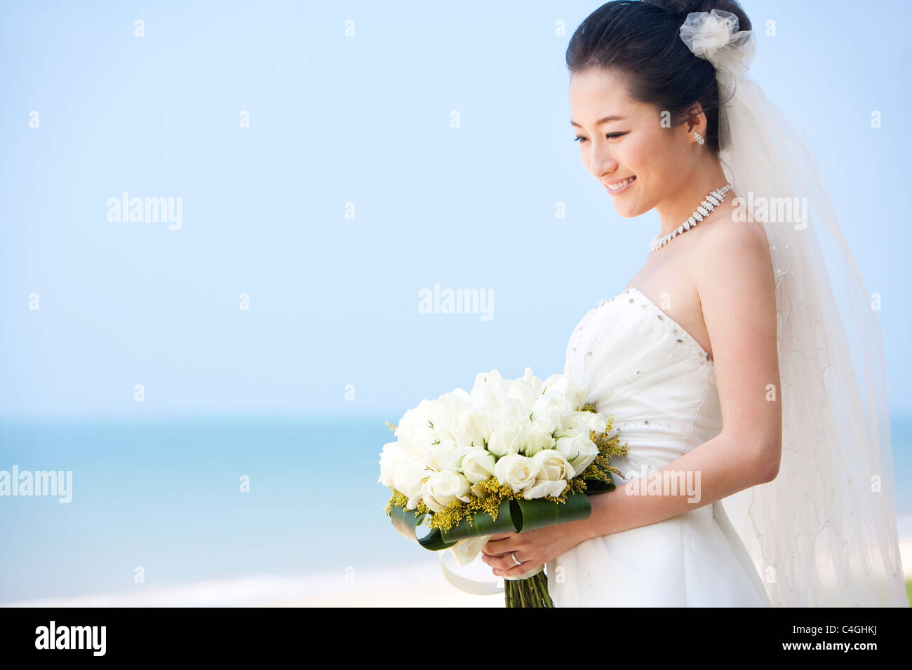 Happy Bride Relaxing on the Beach Stock Photo - Alamy