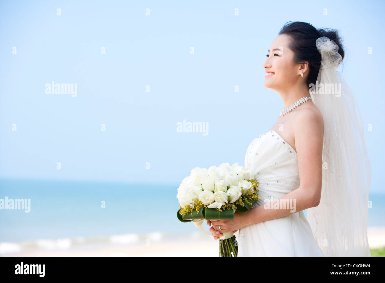 Happy Bride Relaxing on the Beach Stock Photo - Alamy