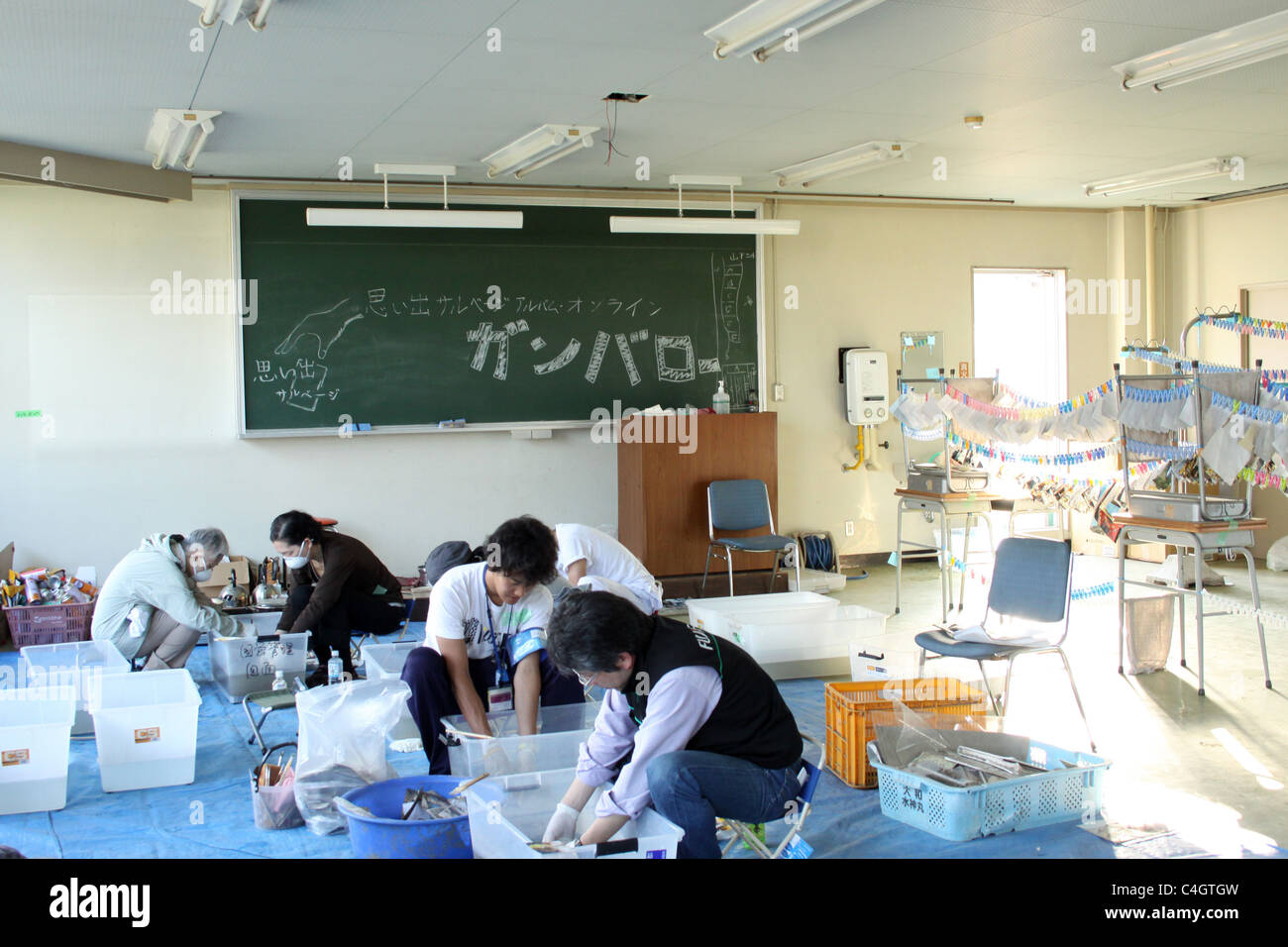 Three months after the devastating earthquake, volunteers work for ...