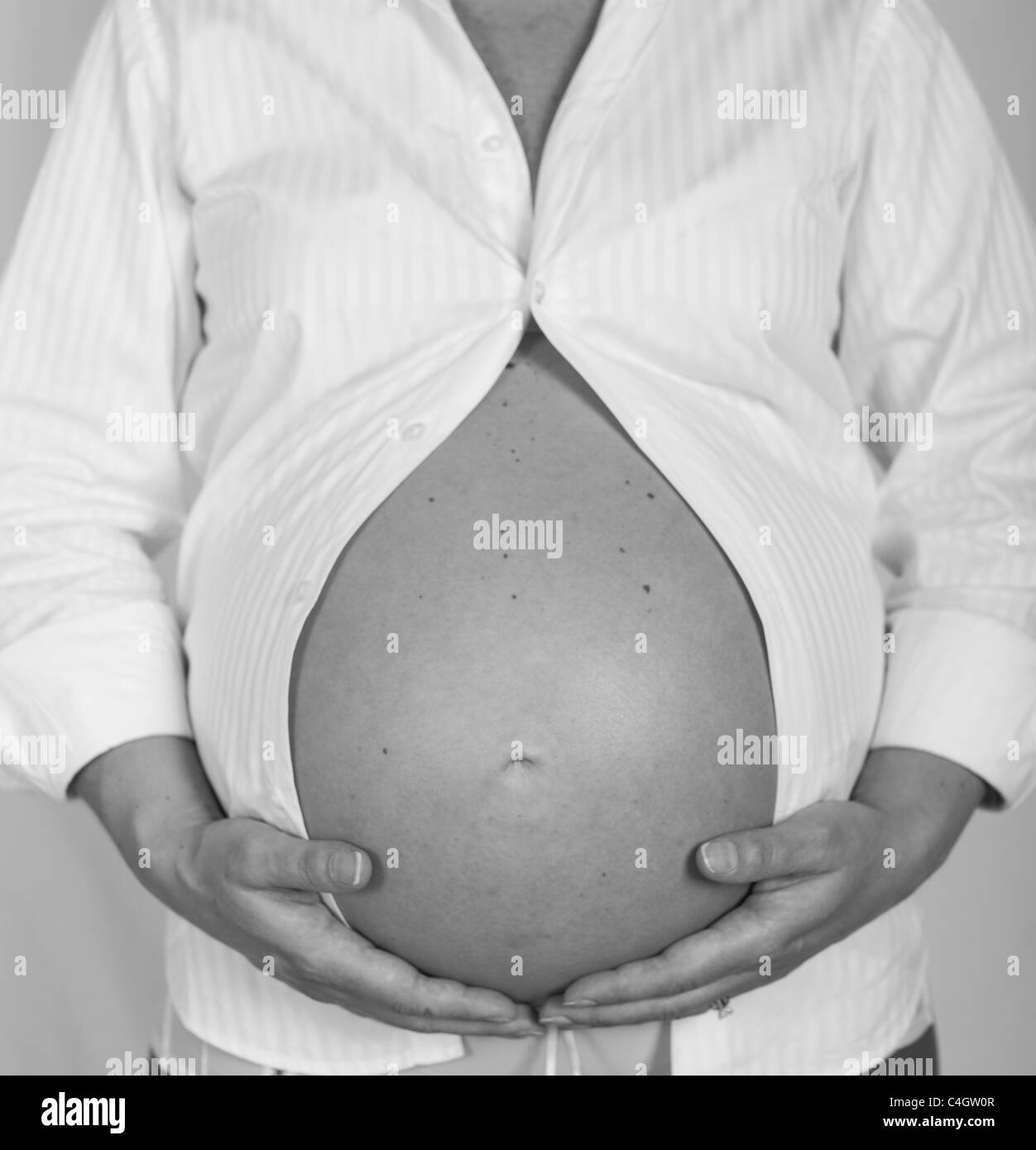 Pregnant woman holding belly Stock Photo - Alamy Pregnant woman holding belly Stock Photo - Alamy